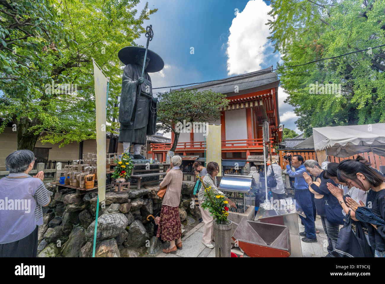 Visitors pay their respects at the Jokoro and bronze statue of the ...