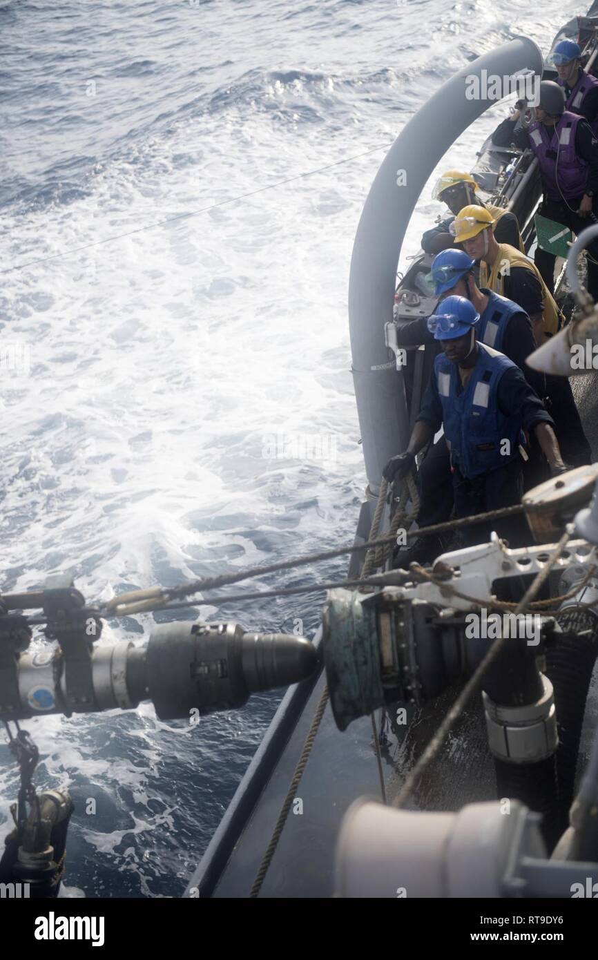 U.S. Sailors observe a probe assembly from the fleet replenishment ...