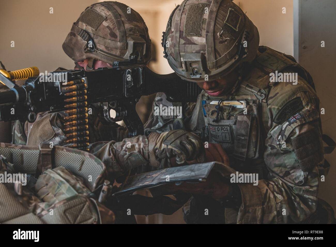 U.K. Royal Marines with 45 Commando analyzes a map of Range 220 during ...