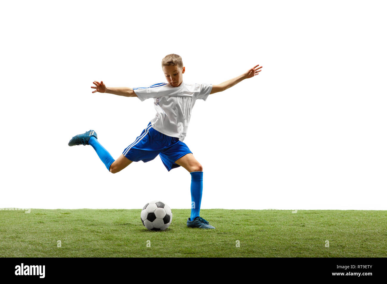 Young boy with soccer ball running and jumping isolated on white ...