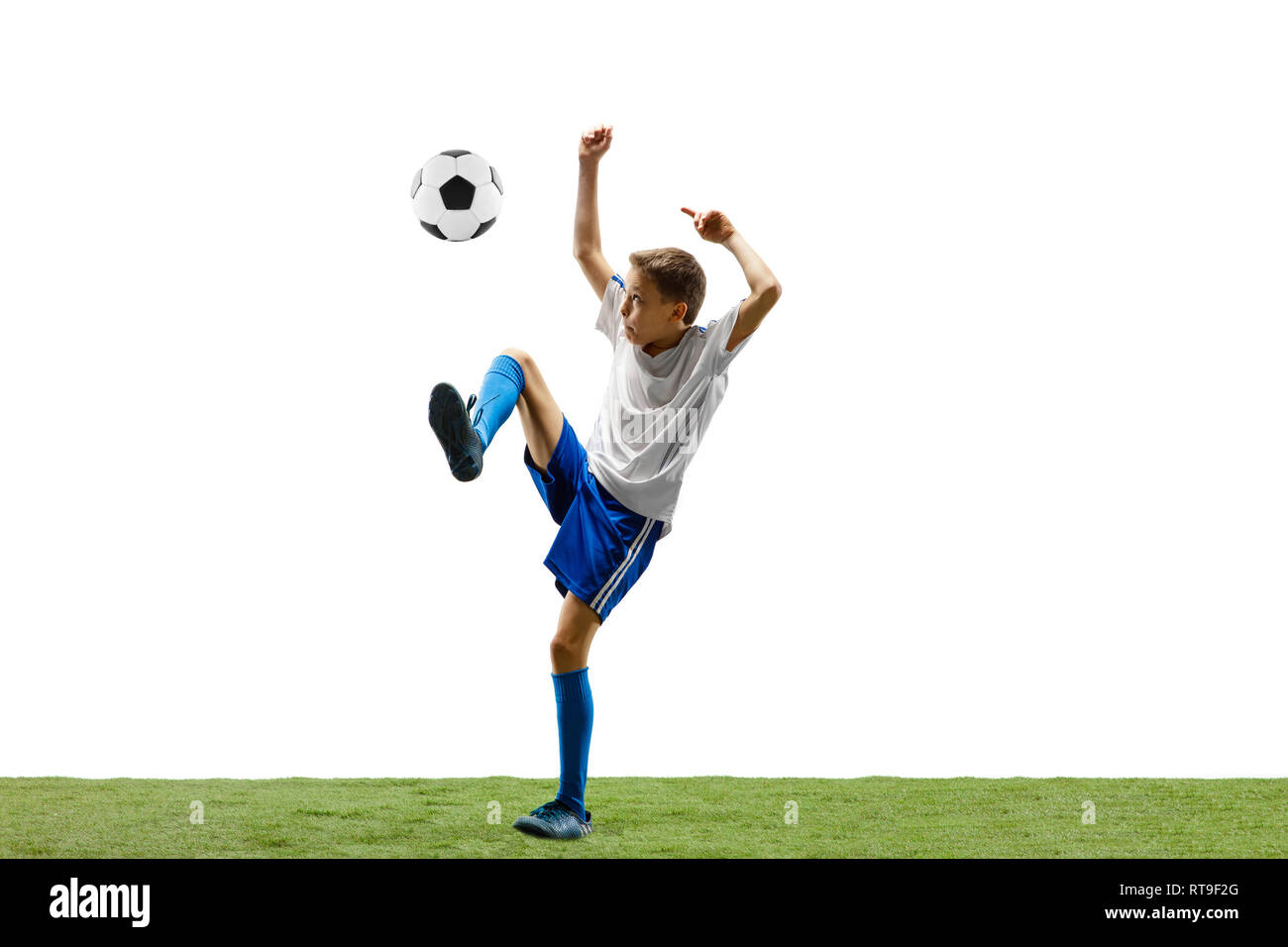 Young boy with soccer ball running and jumping isolated on white ...