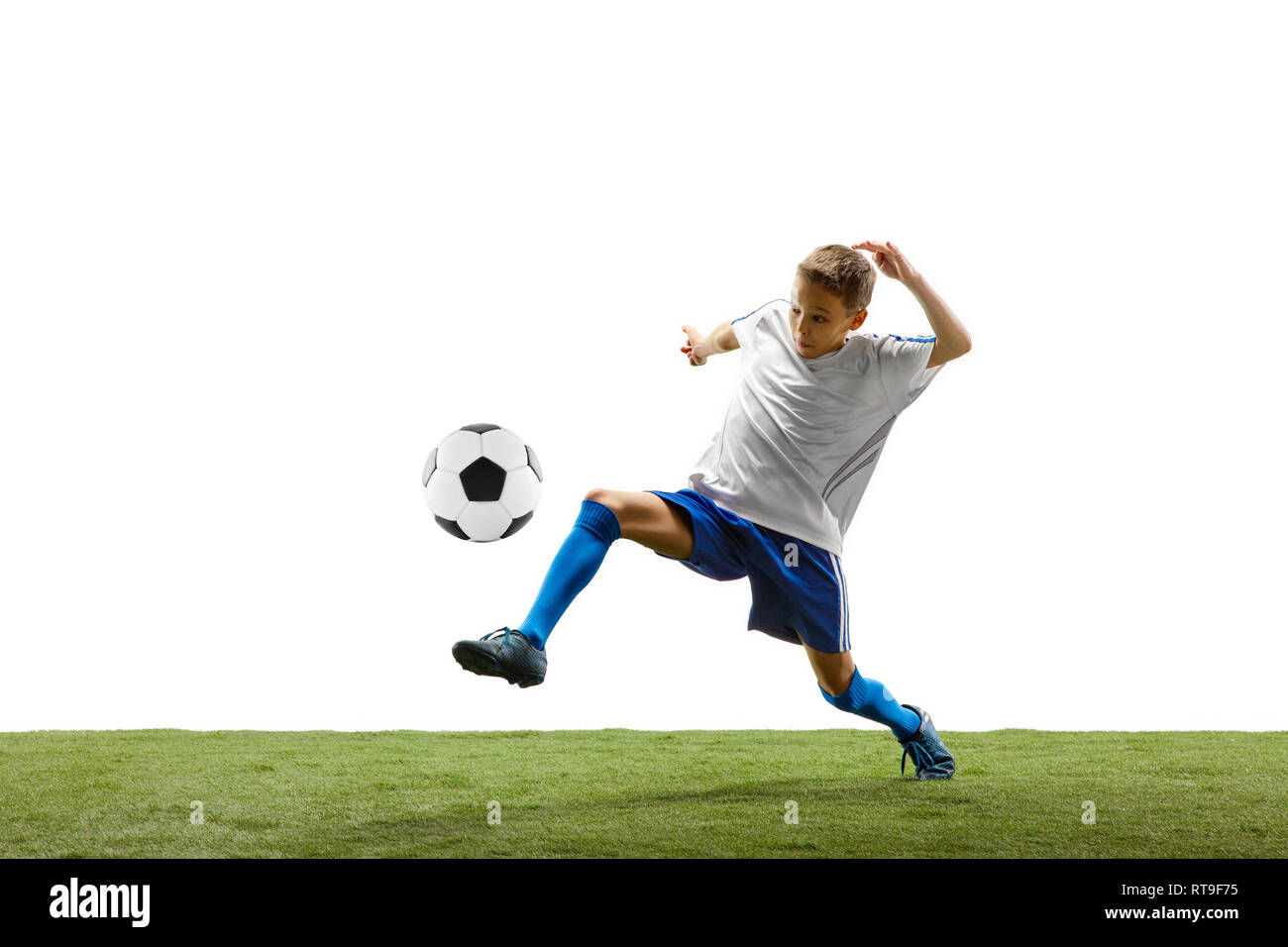 Young boy with soccer ball running and jumping isolated on white ...