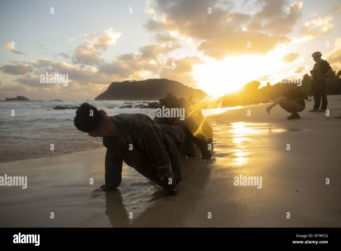 U.S. Marines execute squad push-ups during a physical training exercise ...