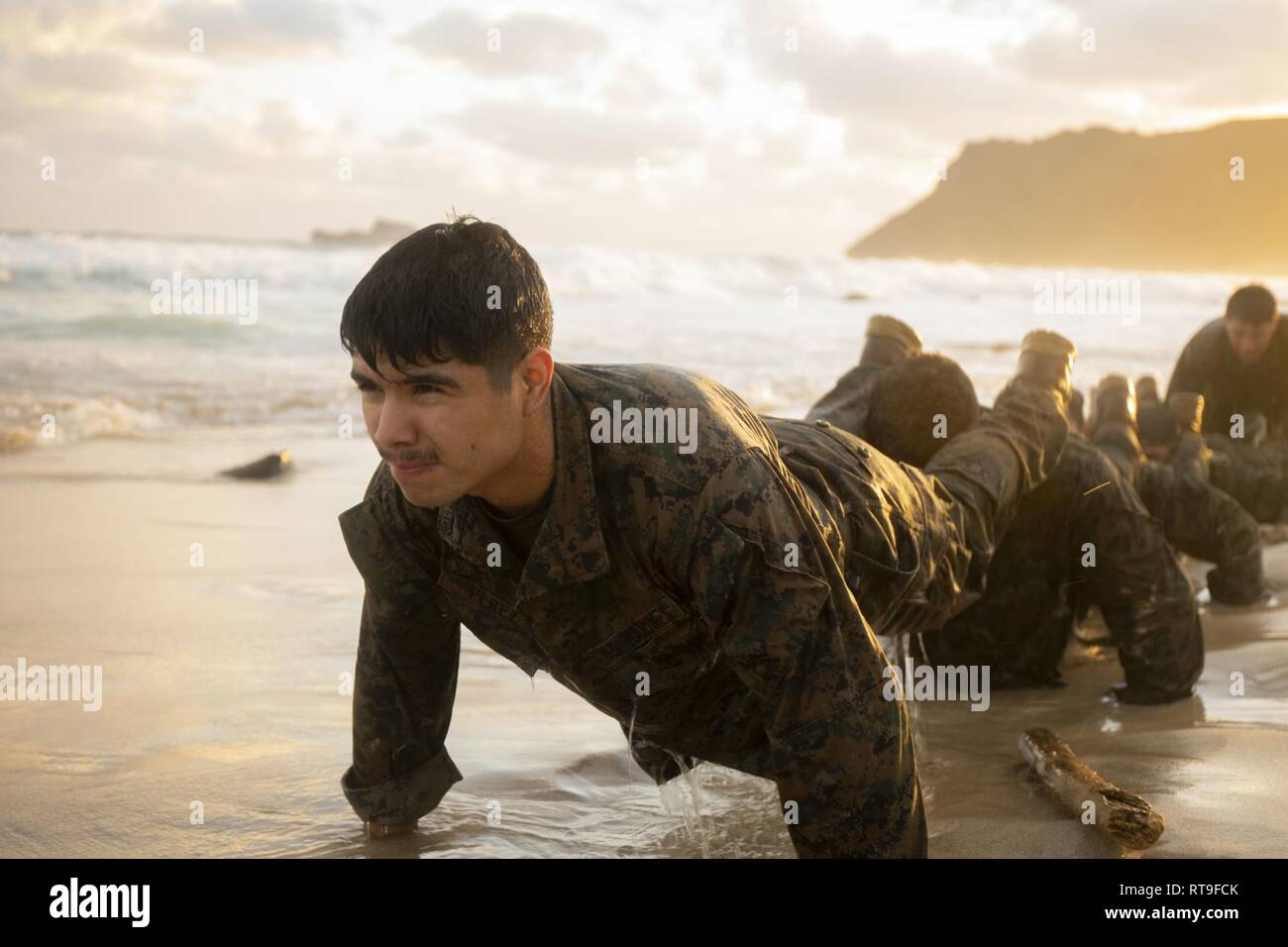 U.S. Marine Corps Cpl. Bobby Perez conducts a squad push-up in part of ...