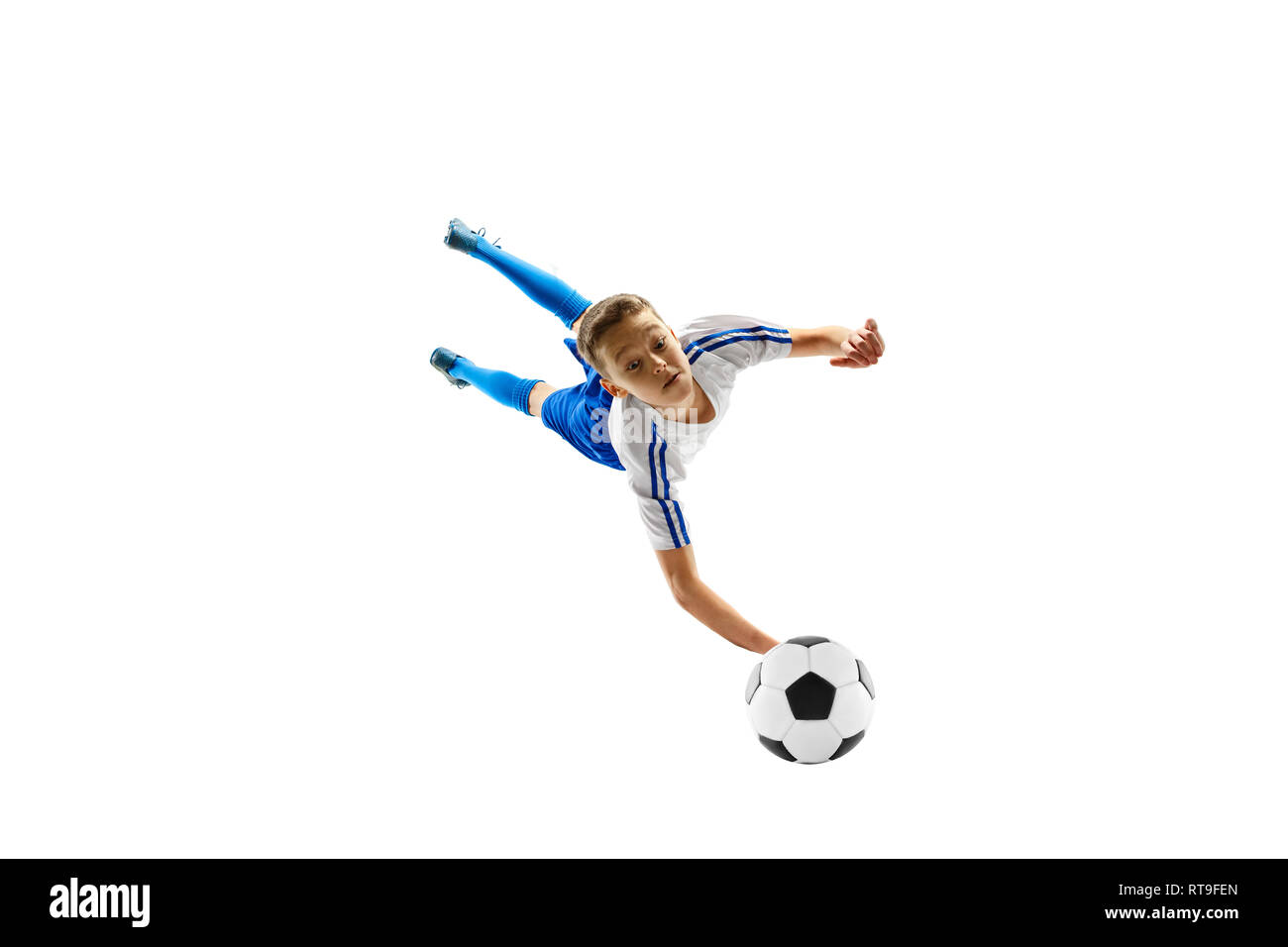 Young boy with soccer ball running and jumping isolated on white ...