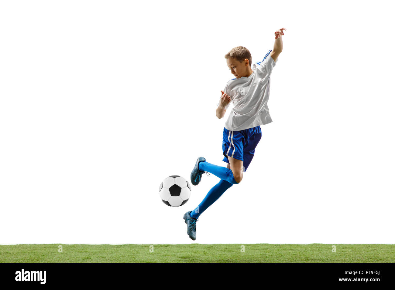 Young boy with soccer ball running and jumping isolated on white ...