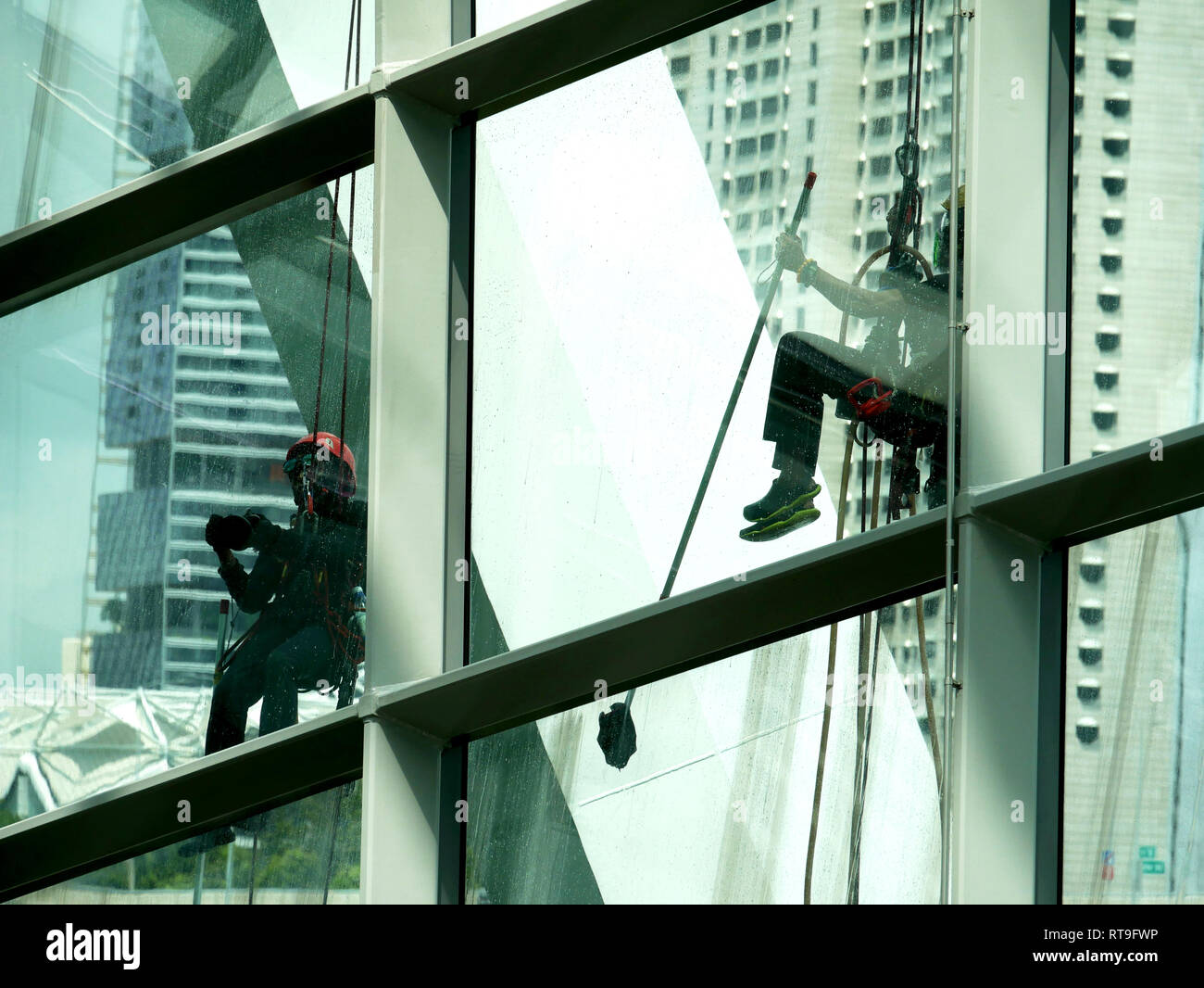 Window washers on skyscraper Stock Photo - Alamy