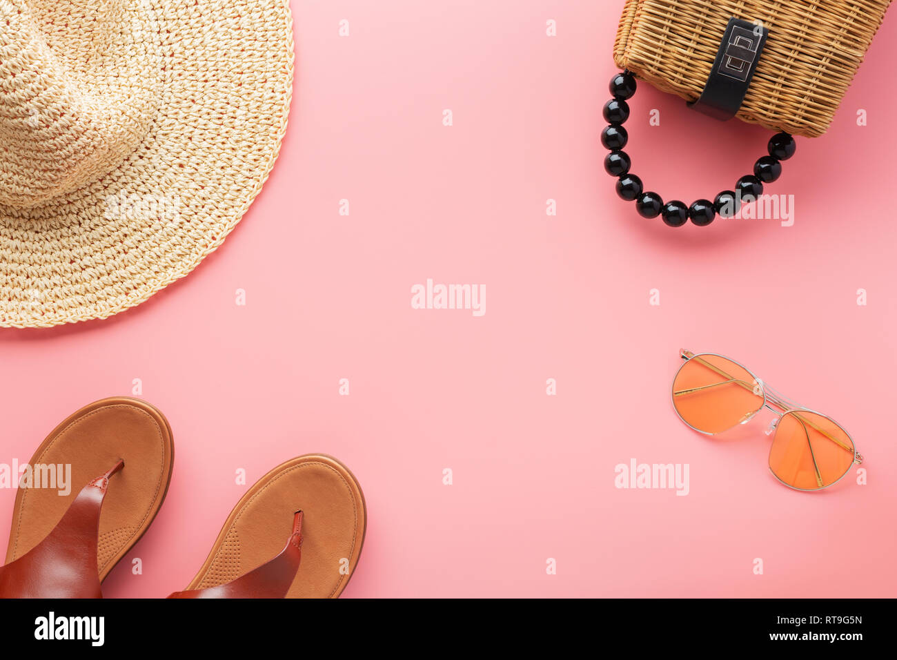 Summer fashion background on pink, trendy straw bag, fedora hat ...