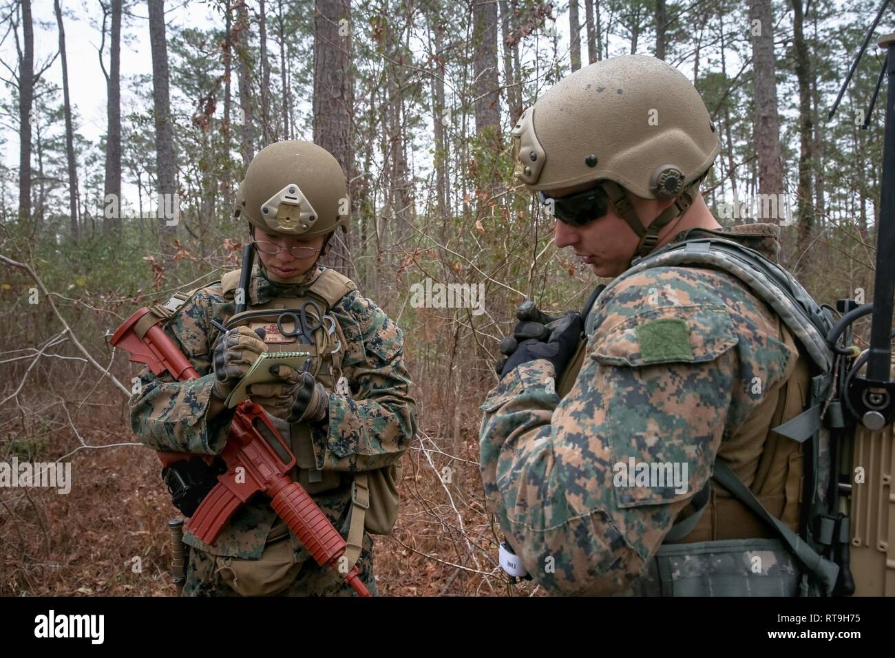 Explosive ordnance disposal (EOD) technicians, take down notes during a ...