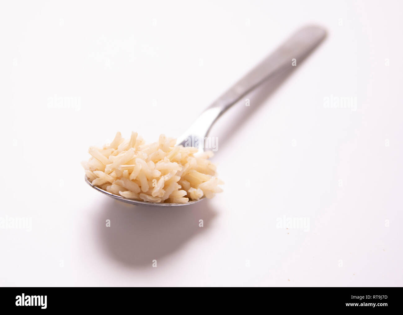 One tablespoon of food. Portion control. Brown rice Stock Photo - Alamy