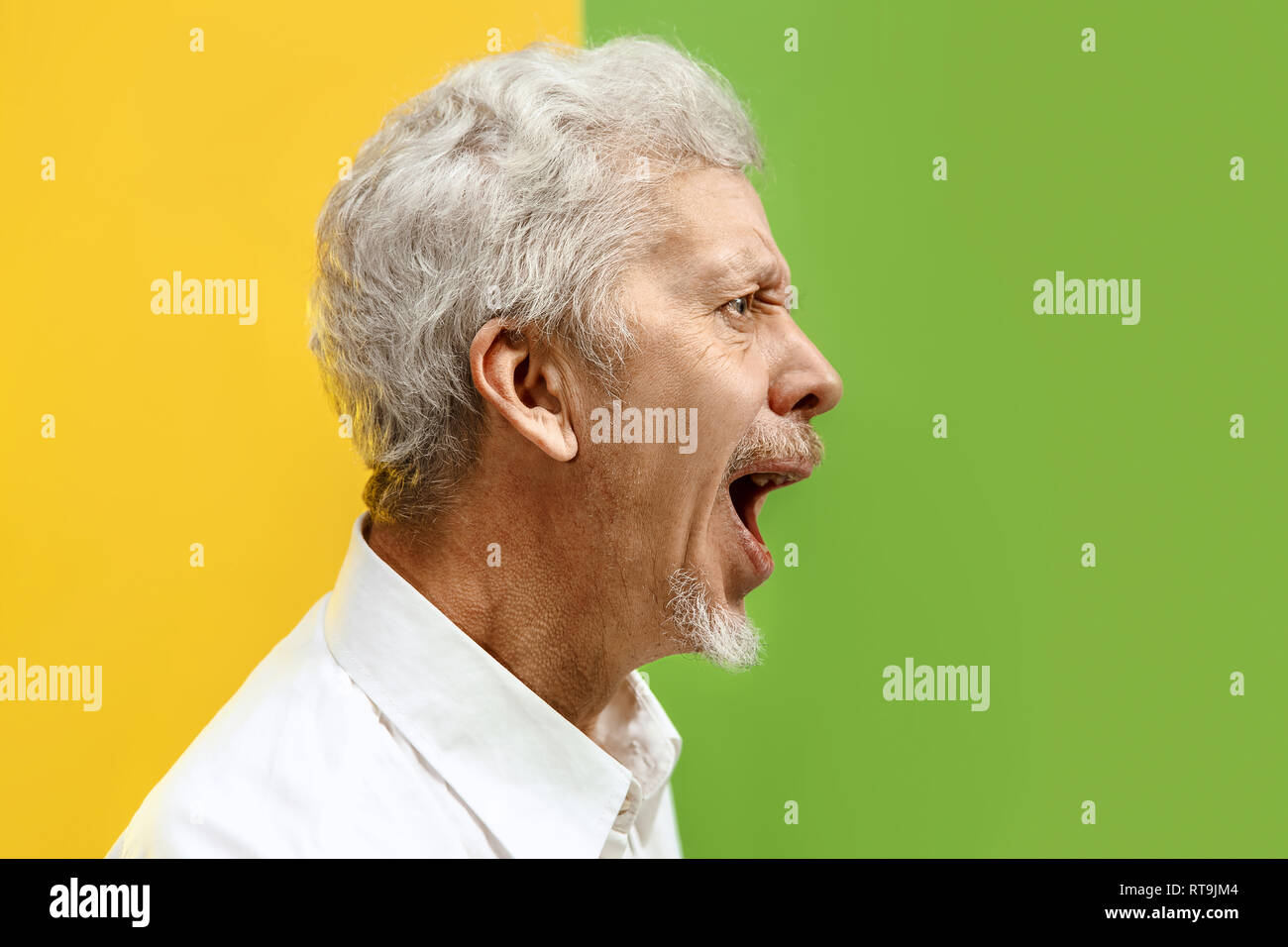 Screaming, hate, rage. Crying emotional angry man screaming on studio ...