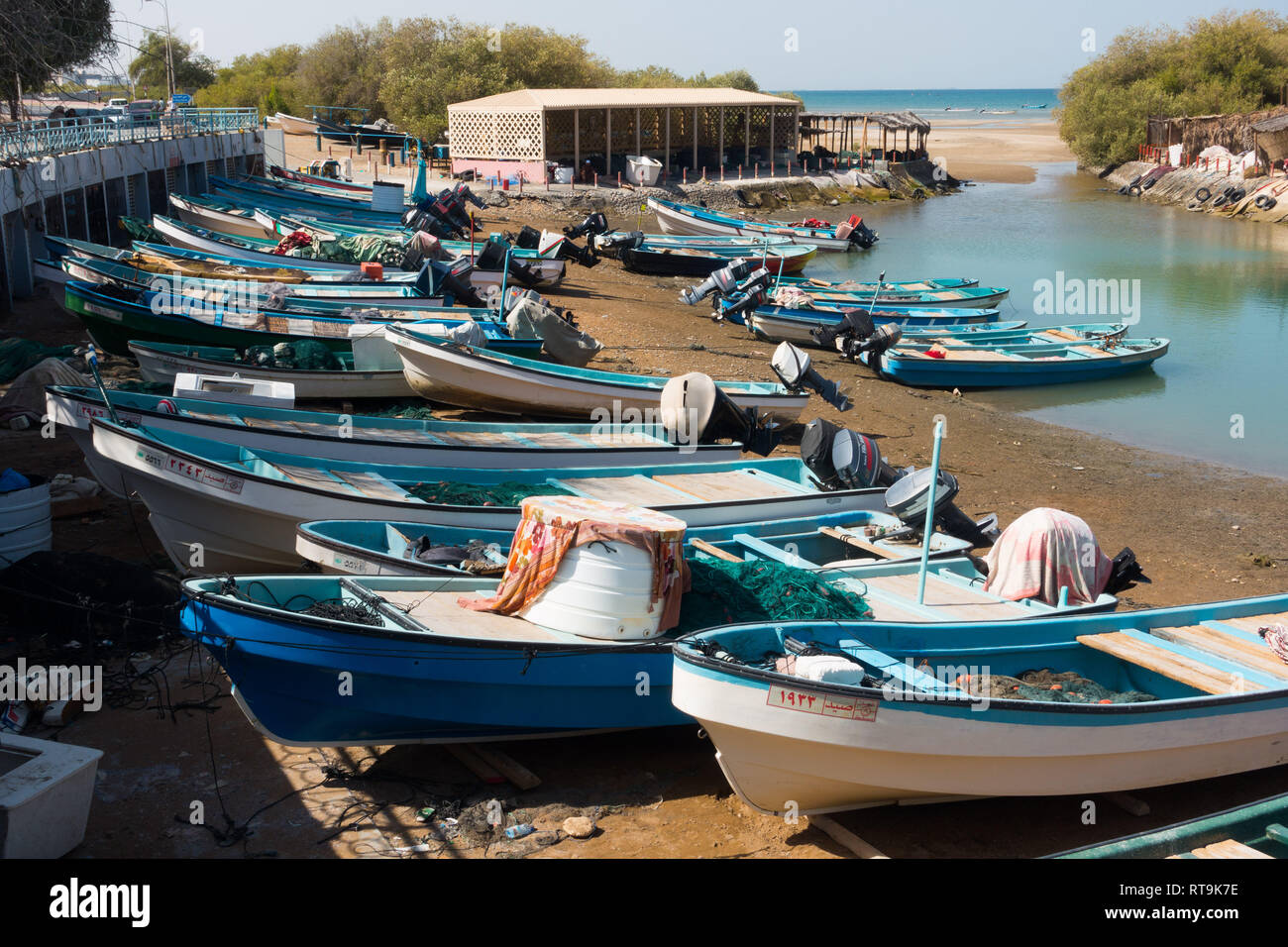 Fishing boats lined up on Qurum Beach, Muscat, Oman - a small inlet at ...