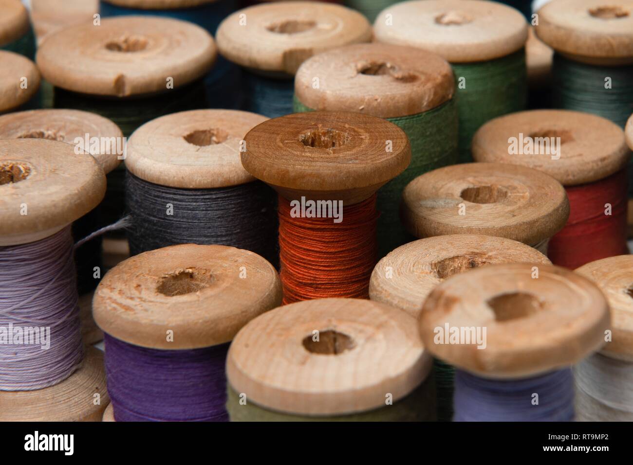 wooden coils with colorful threads of pastel colors Stock Photo - Alamy