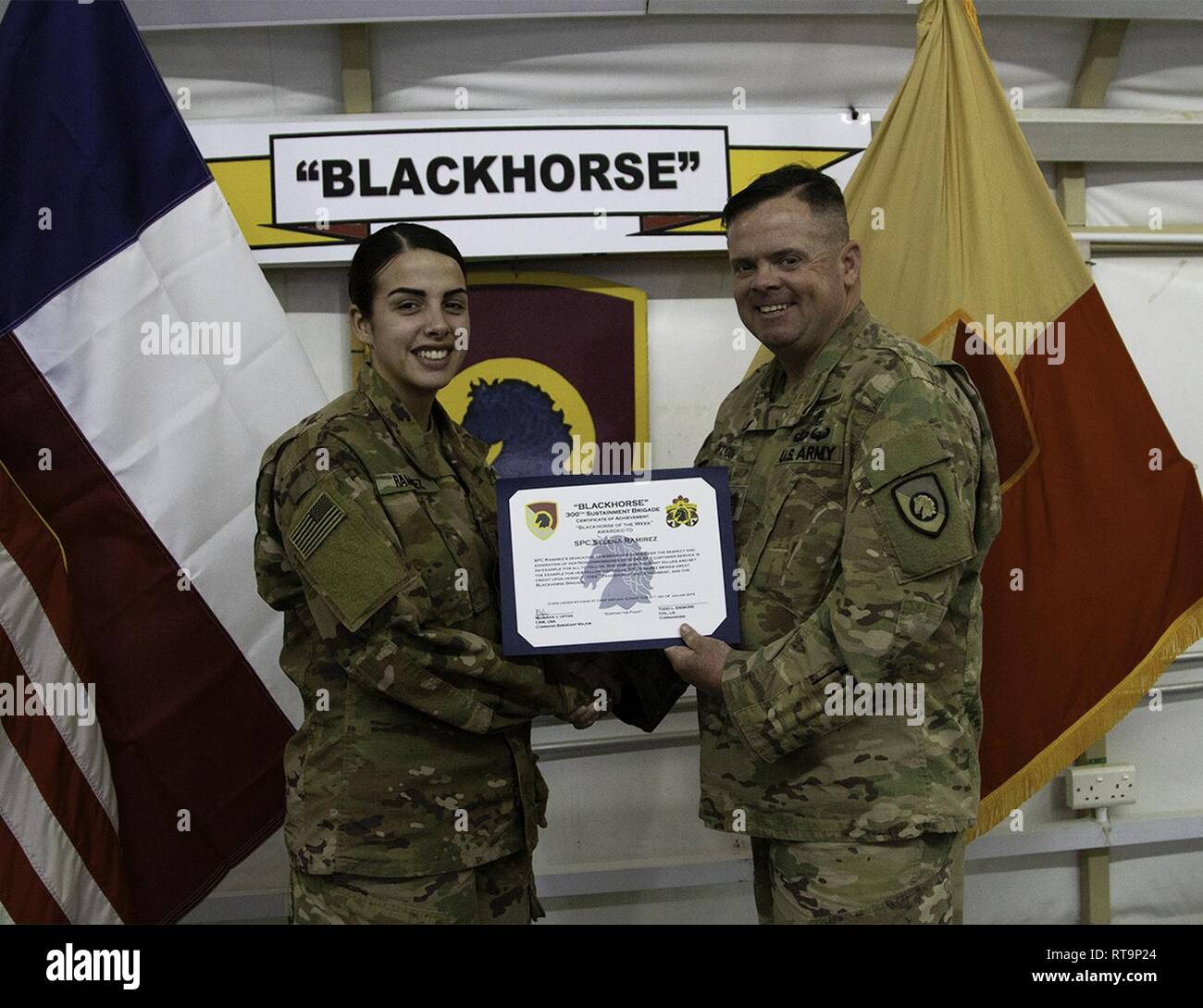 Spc. Selena Ramierz with the 1099th Transportation Detachment receives ...