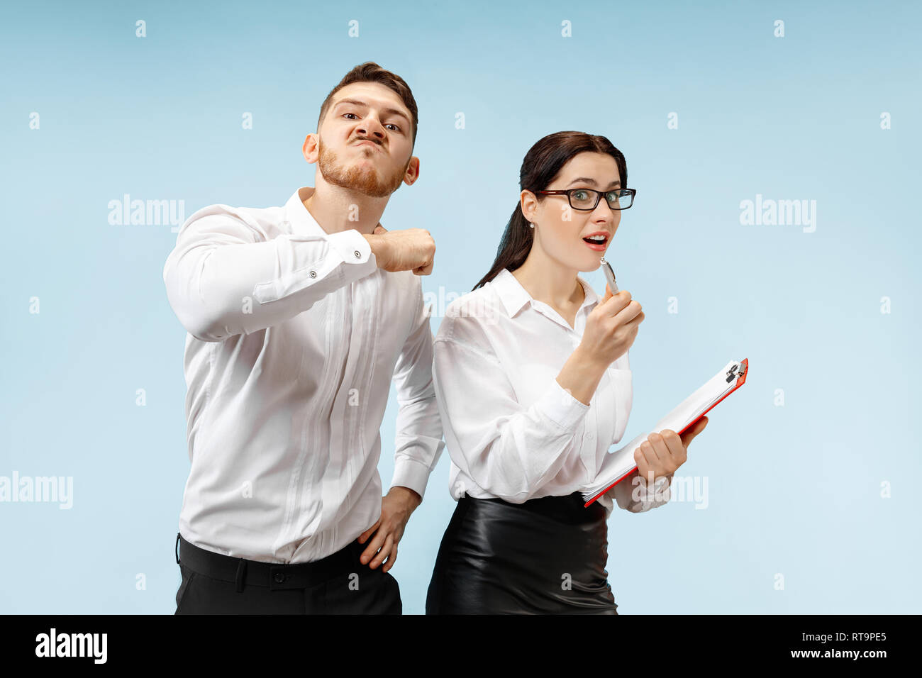 Angry boss. Man and his secretary standing at office or studio ...