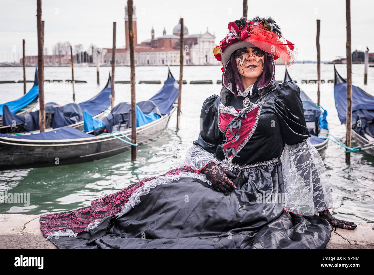 Beautiful masked woman during the carnival in Venice(Italy) standing ...