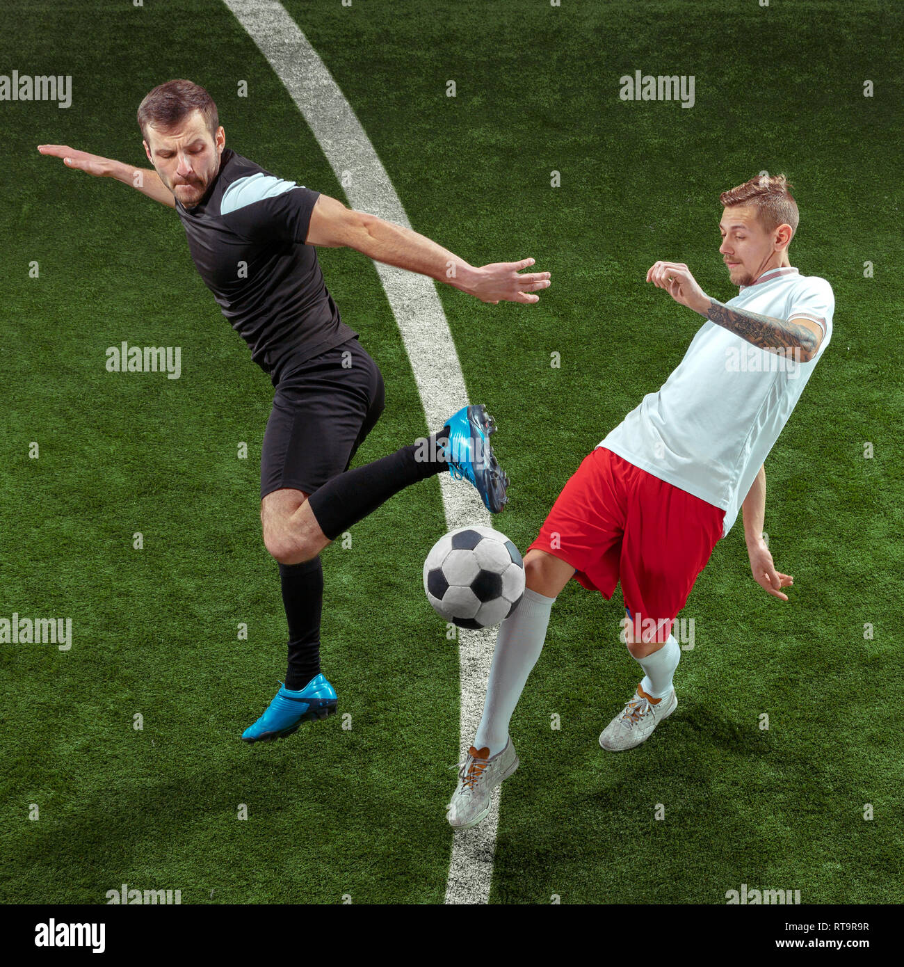 Football player tackling for ball over green grass background ...