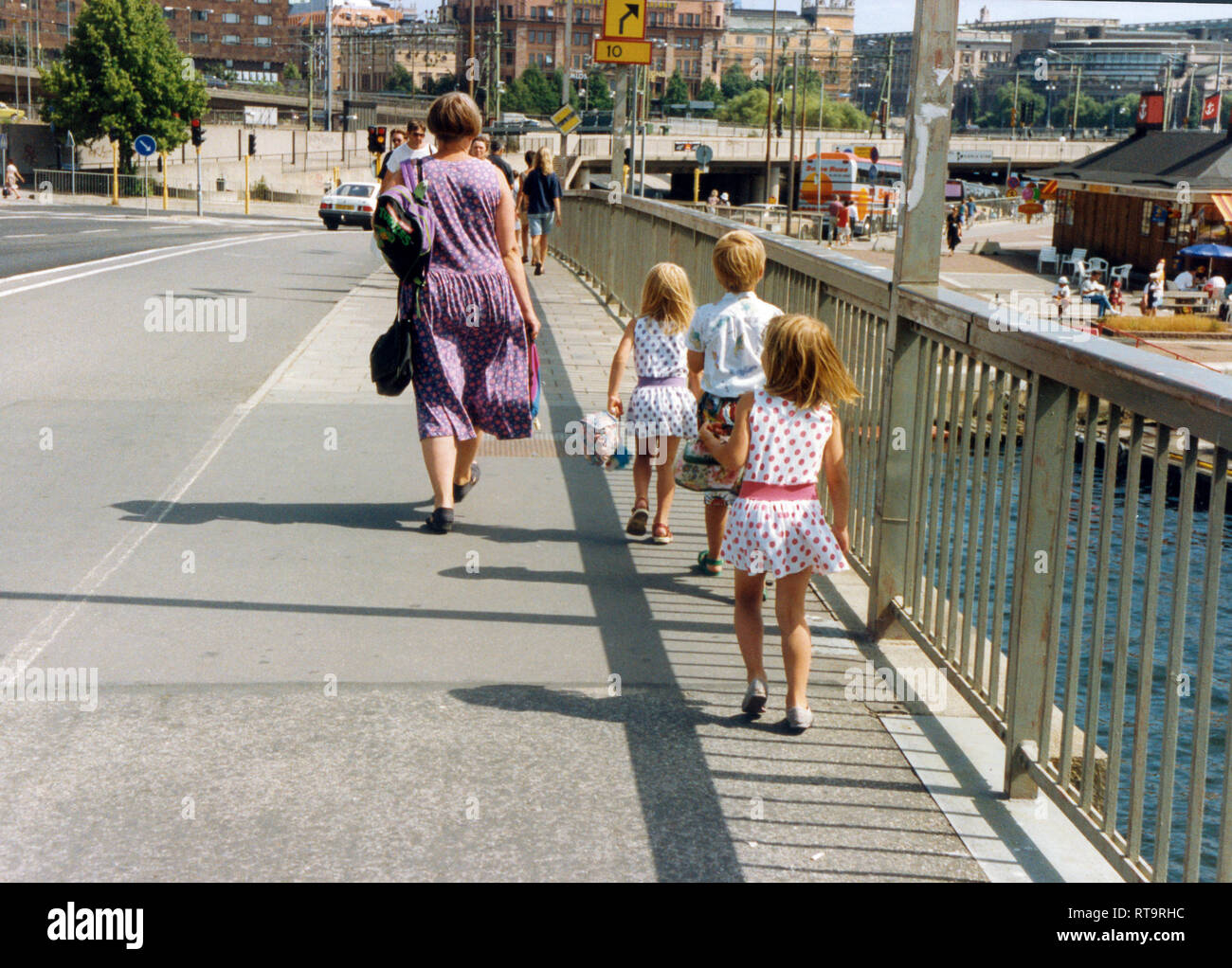 Children follows the mother in the City Stock Photo - Alamy