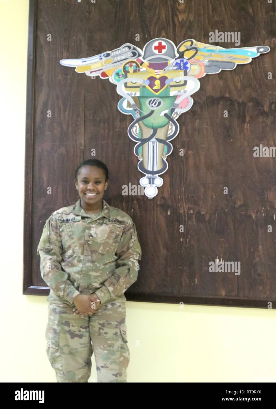 Sgt. Sylvia Mwangi, 452d Combat Support Hospital, poses near a caduceus ...