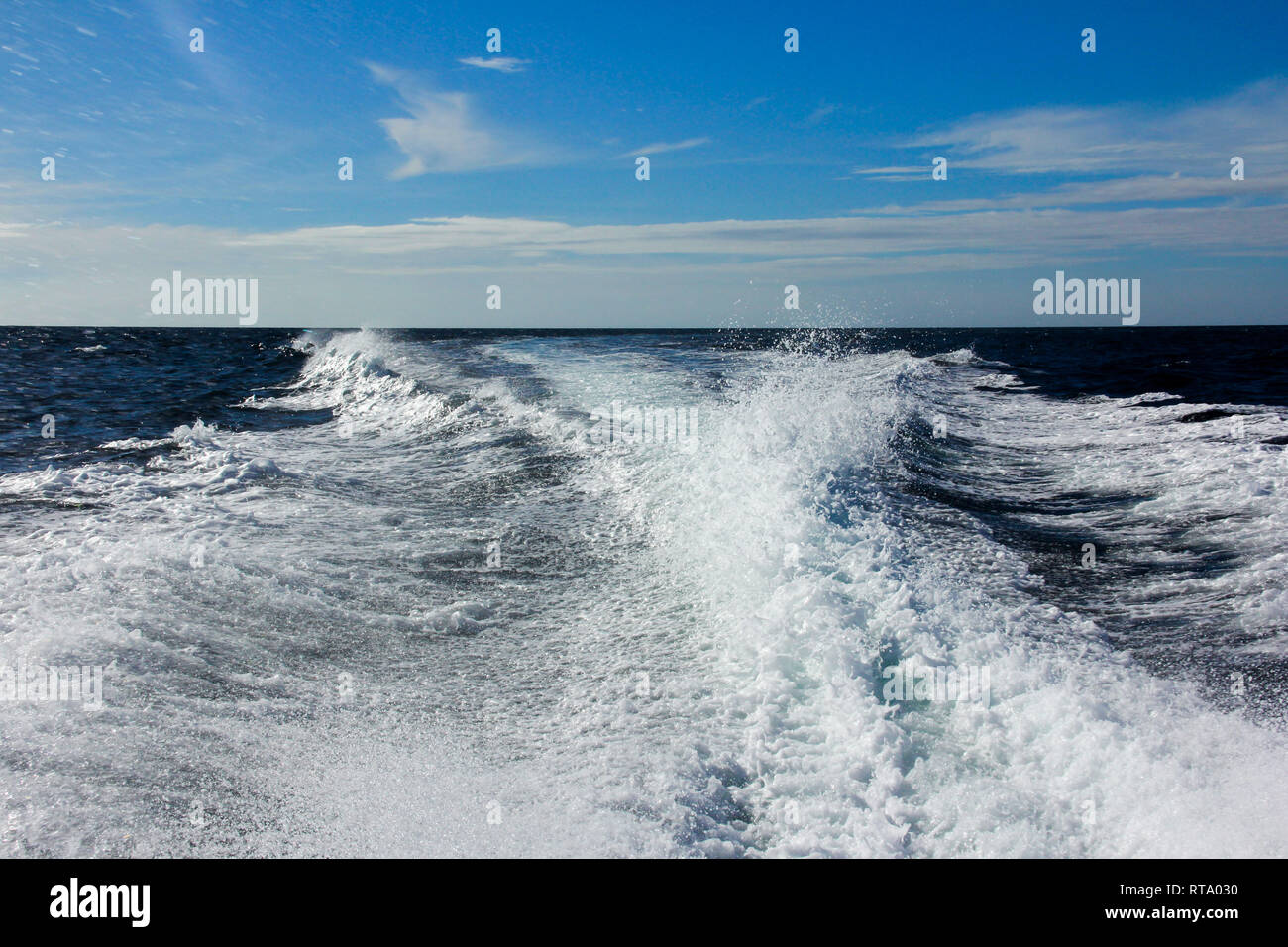 A speed boat wake speedy prop wash foam in Andaman sea with blue sky ...