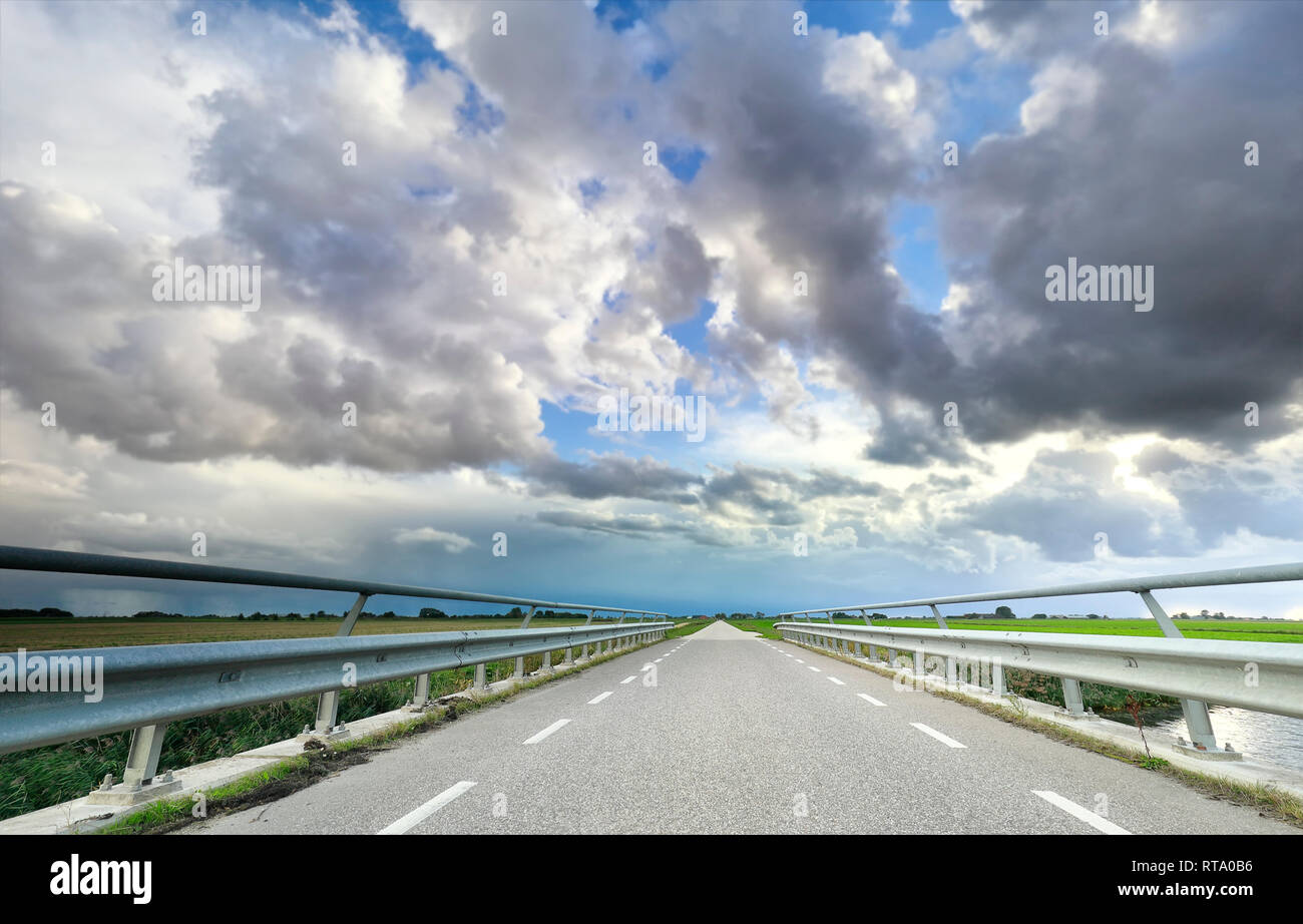 a motor way, horizon and blue sky with clouds im summer Stock Photo - Alamy