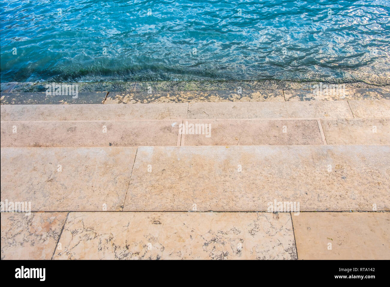 A marble quay of the venetian canal.Turquoise adriatic water Stock ...