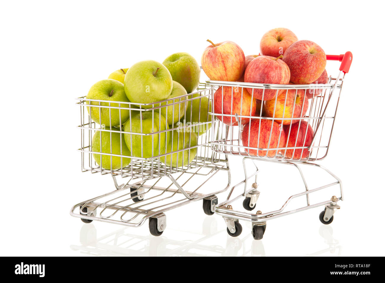 Green and red apples in shopping cart isolated over white background ...