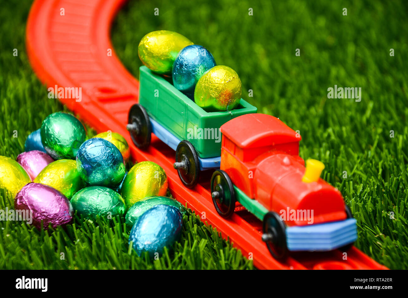 Pile of Easter Eggs waiting to be transported by toy train on tracks on ...