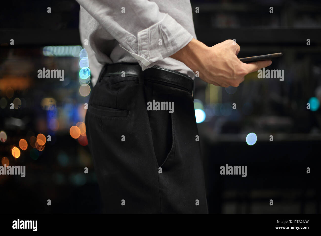 businessman checking on mobile phone in a modern office with out of ...