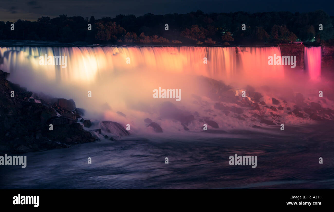 Niagara Falls at night seen from Canadian side, illuminated by colorful ...