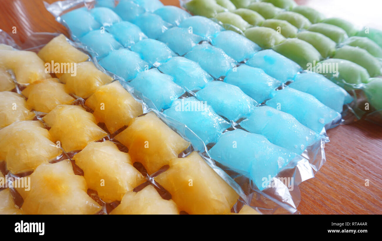 Colorful ice cubes background - frozen fruit ice Stock Photo - Alamy