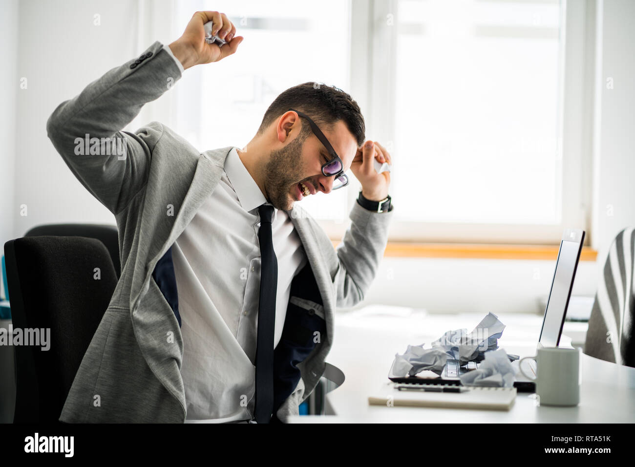 Young businessman is angry and frustrated Stock Photo - Alamy