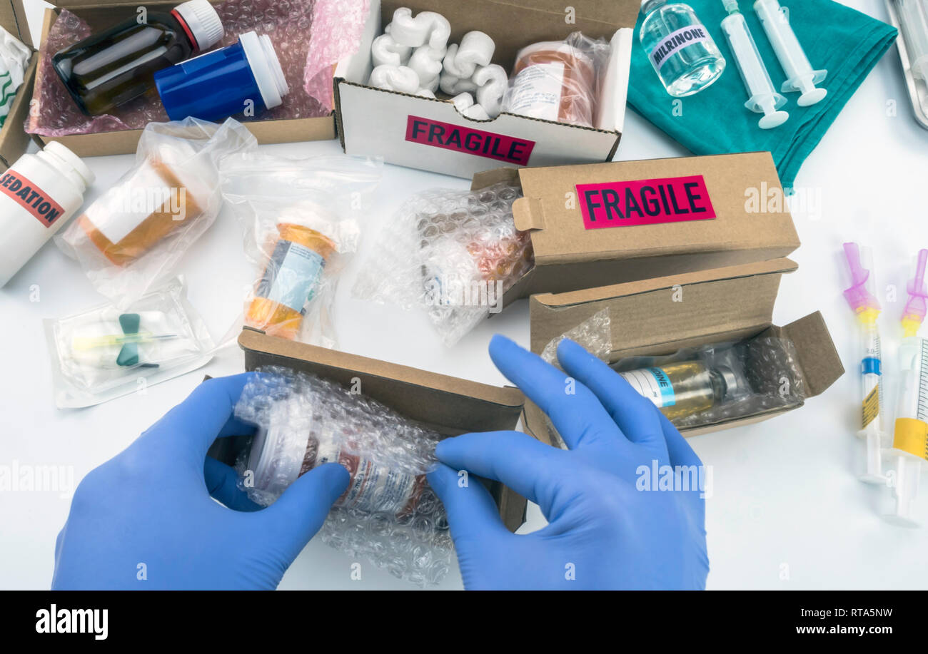 Nurse unpacking medication in boxes, conceptual image, horizontal ...