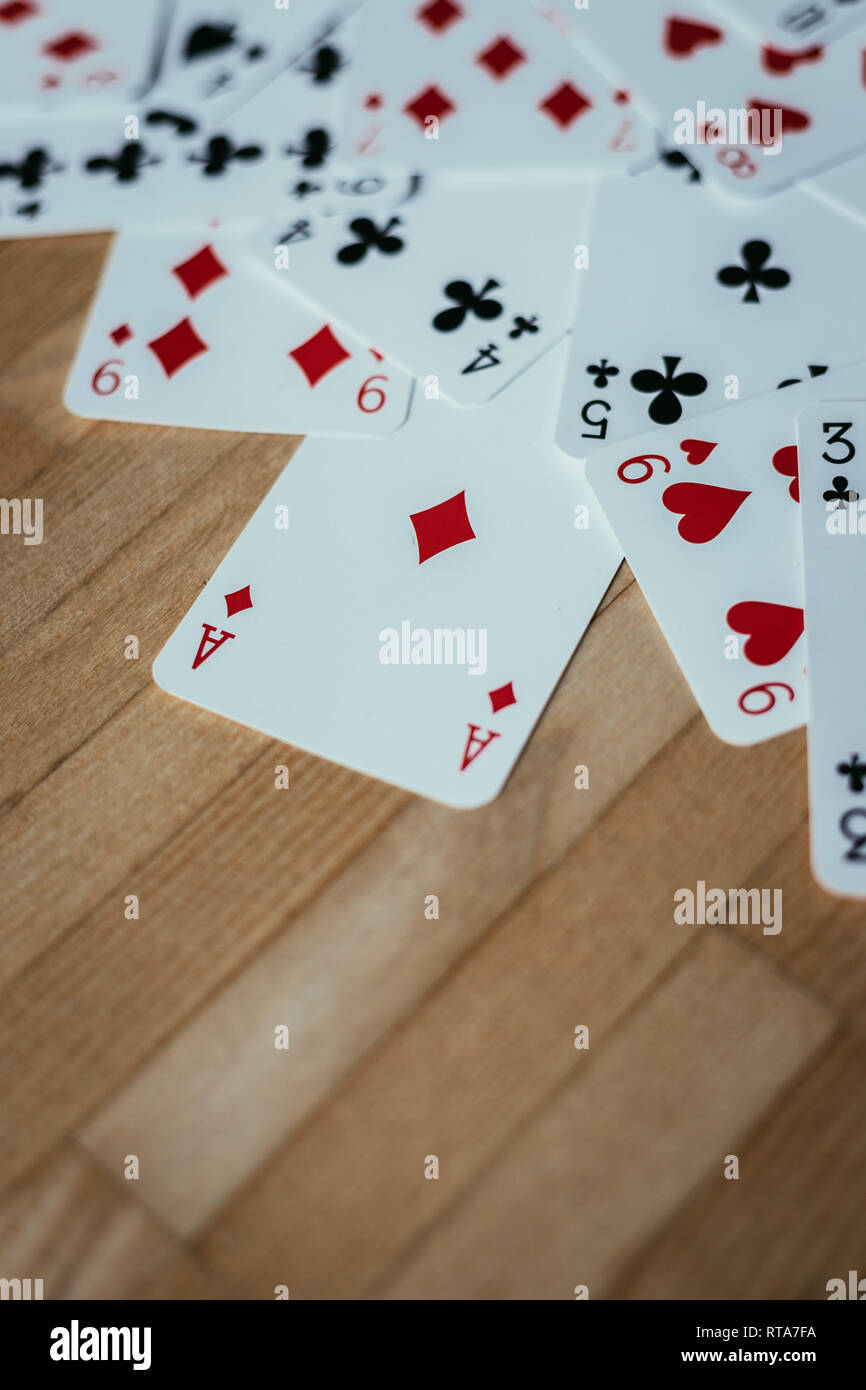 Gaming cards are lying on wood table. Playing cards at home, copy space ...