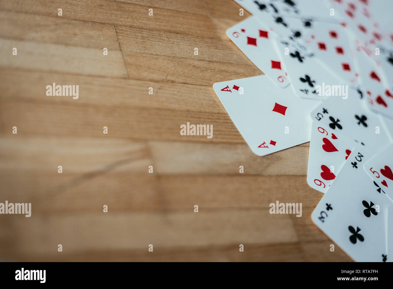 Gaming cards are lying on wood table. Playing cards at home, copy space ...