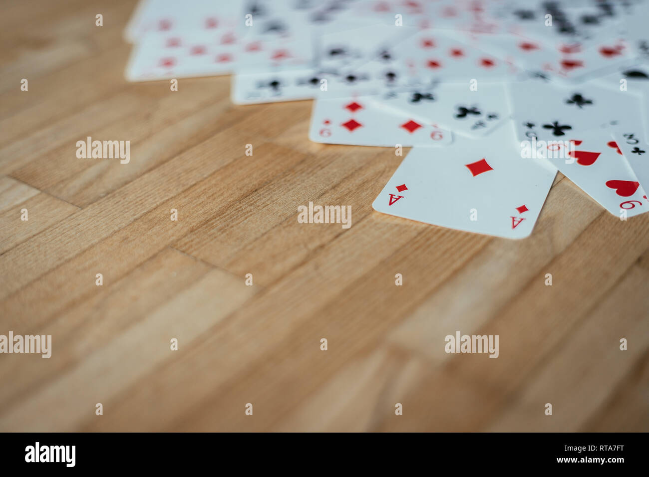 Gaming cards are lying on wood table. Playing cards at home, copy space ...