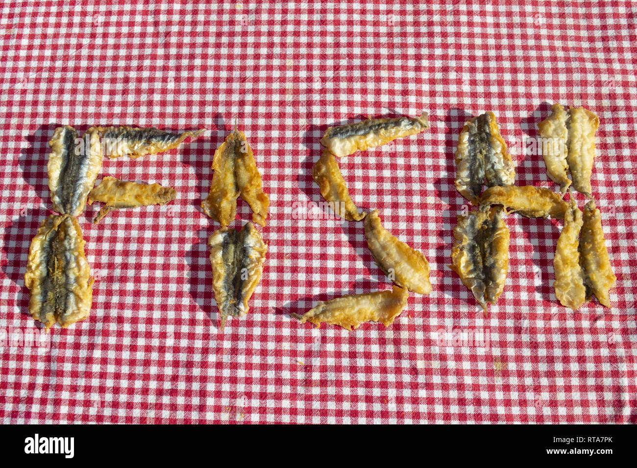 fish word written with fritters of anchovy fillets Stock Photo - Alamy