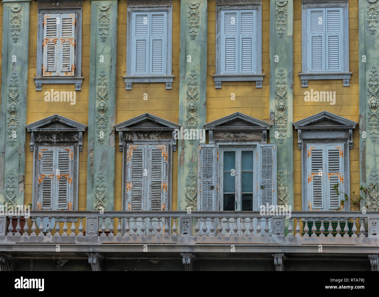 Vintage historical building facade with three antique windows ...