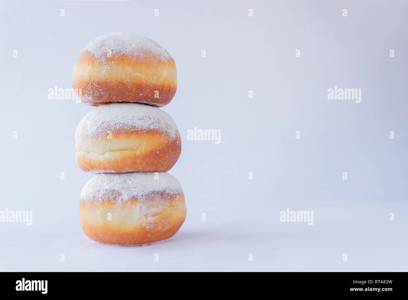 Three fresh doughnuts stacked on each other on white background Stock ...