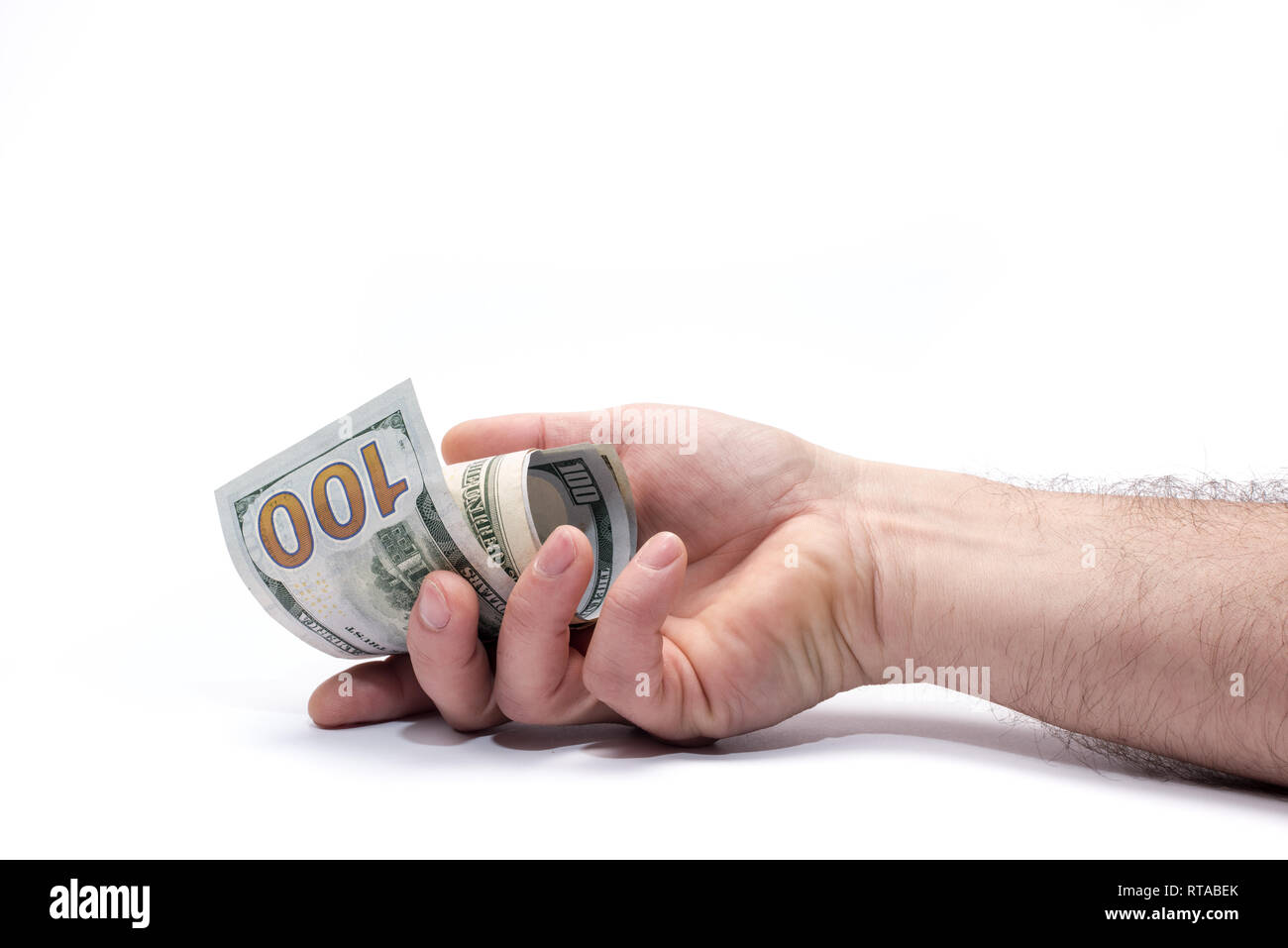 Rolled up hundred dollar banknotes in human hand on white background ...
