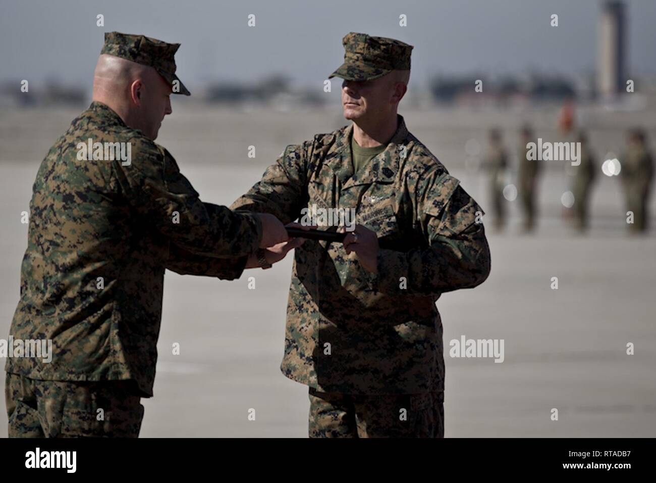 U.S. Marine Corps Sgt.Maj. Keith Massi (Right) is given the NCO sword ...