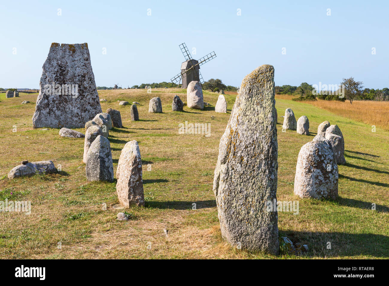Stone ship on a grave field with a windmill Stock Photo - Alamy