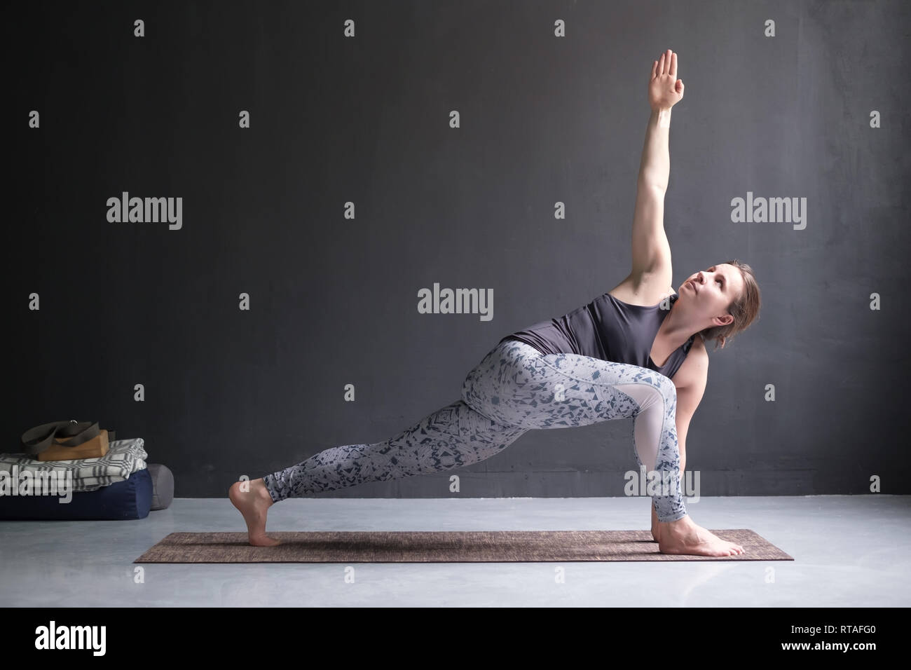 Sporty beautiful young woman practicing yoga, doing lunge exercise ...
