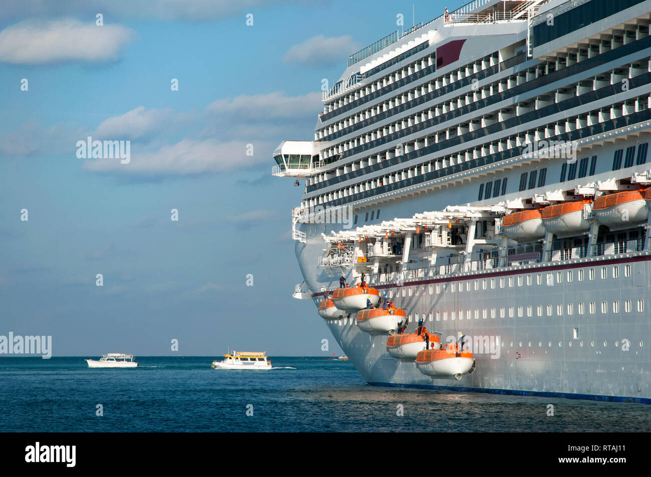 The maintenance crew working on tender boats while the cruise ship is ...