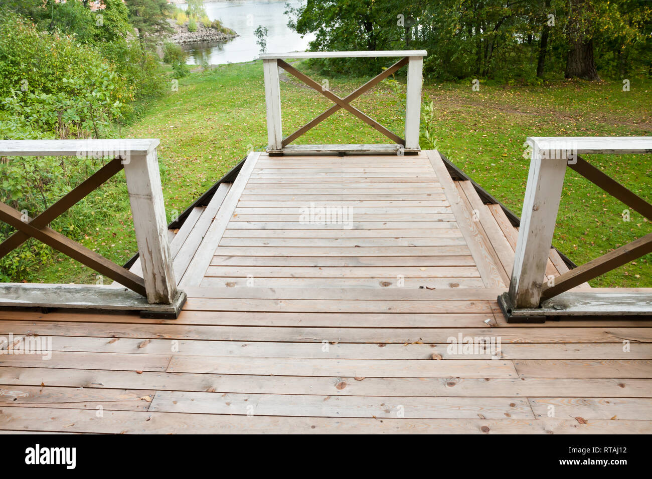 Top view of lake and old wooden porch with staircase, siding house ...