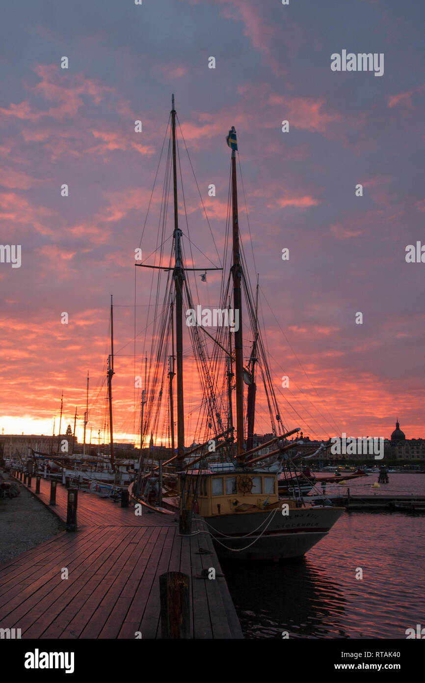 Ship - boat docked in Stockholm, Sweden at sunset. Path with orange ...
