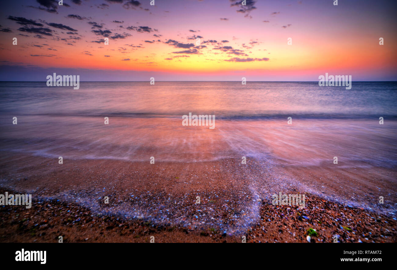 Beautiful sunrise over the beach Stock Photo - Alamy