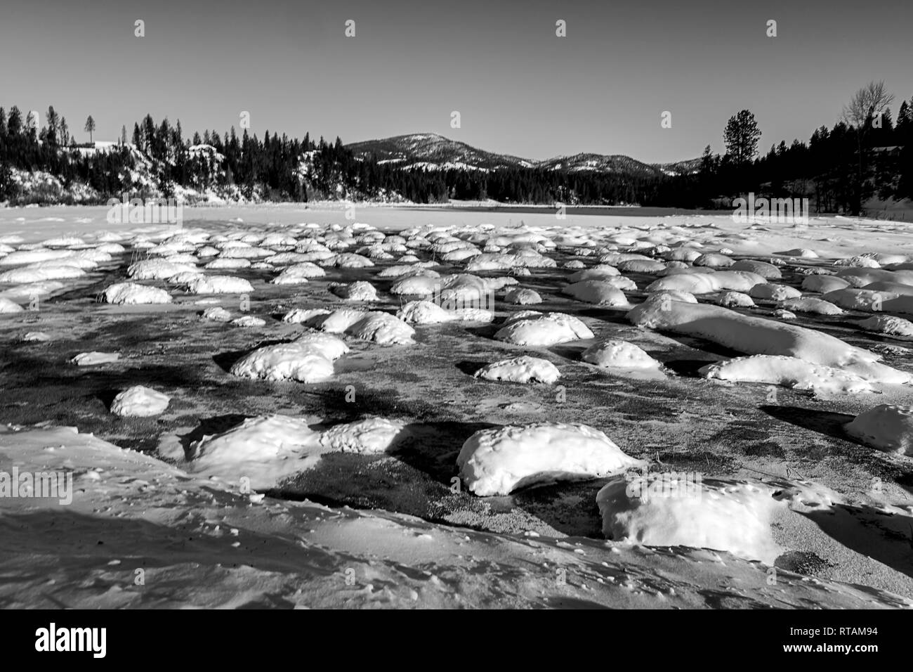 A black & white landscape photo of a cold winter scenic on a clear day ...