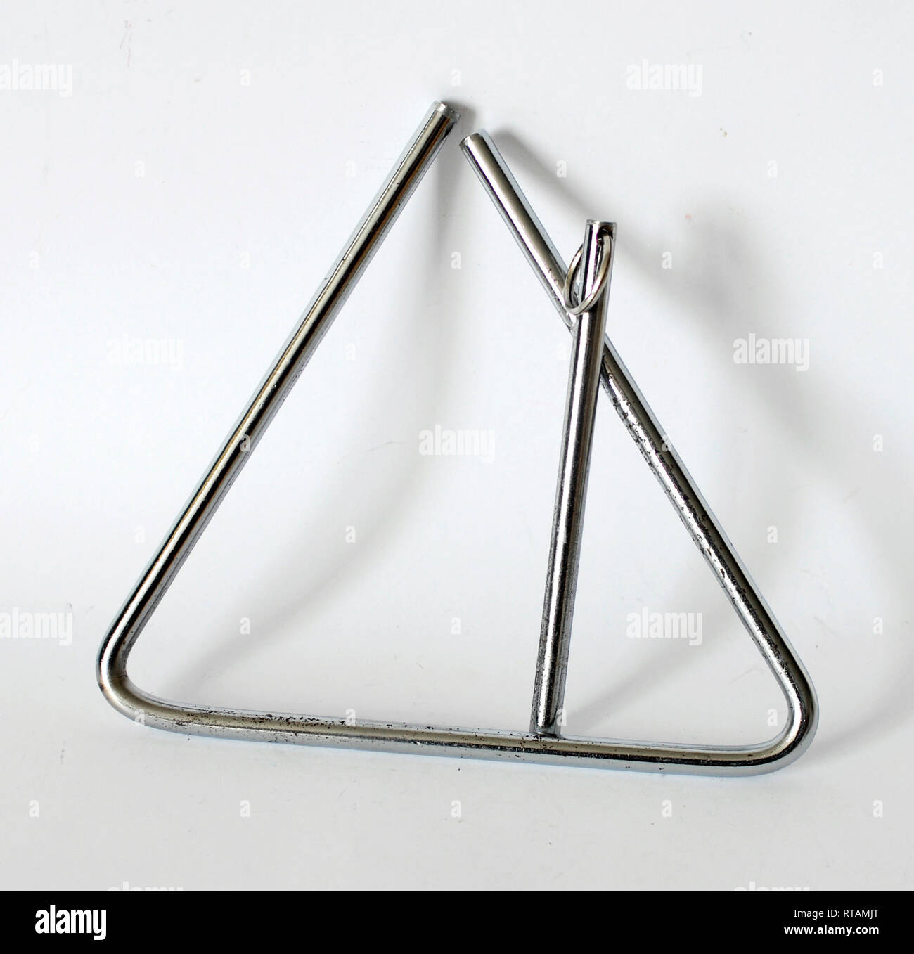 Photograph of triangle musical instrument, isolated on white background ...