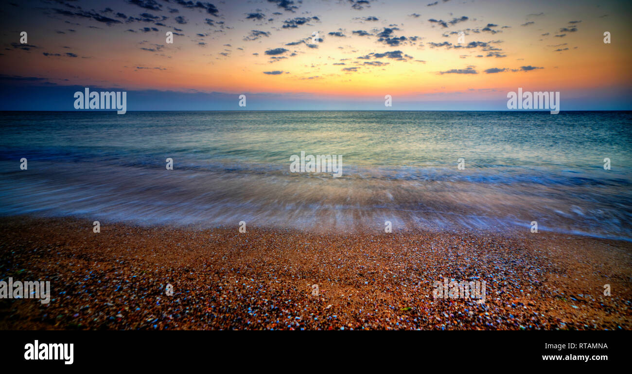 Beautiful sunrise over the beach Stock Photo - Alamy